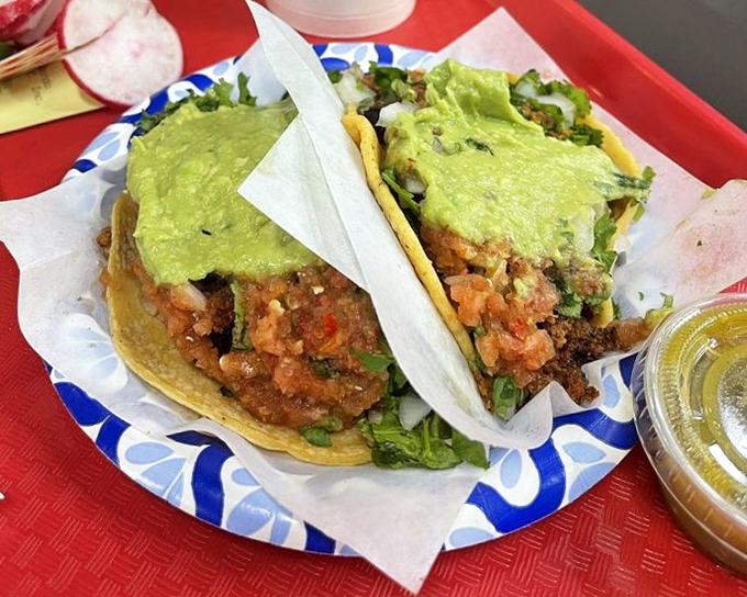 Two taco varieties showcase the kitchen's range: beef and chorizo perfection on handmade tortillas.