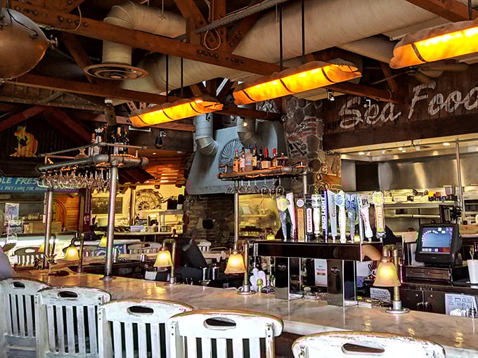 The bar beckons with amber lighting and promises of libations that complement seafood better than lemon itself. Maritime mixology at its finest.