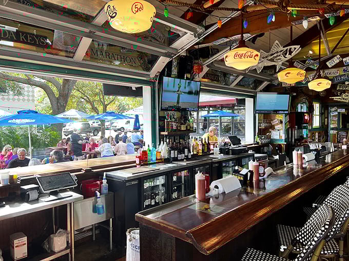 A bar that promises cold drinks and a front-row seat to the kitchen action. Those license plates on the ceiling each tell a story—most involving seafood pilgrimages.