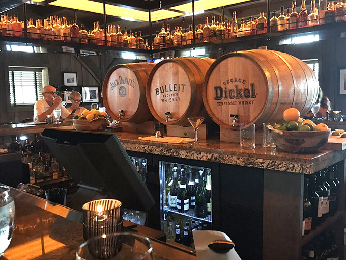 The bar showcases whiskey barrels that aren't just decoration—they're a promise of the bourbon selection that awaits the discerning drinker.
