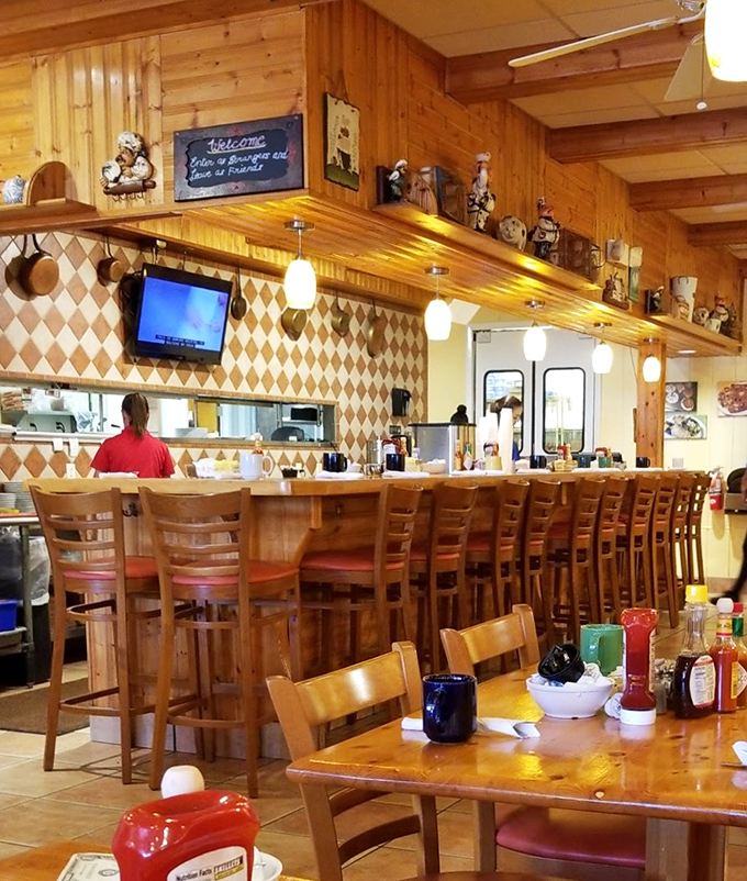 The breakfast bar – where culinary magic happens behind the scenes while collectibles stand guard from above.