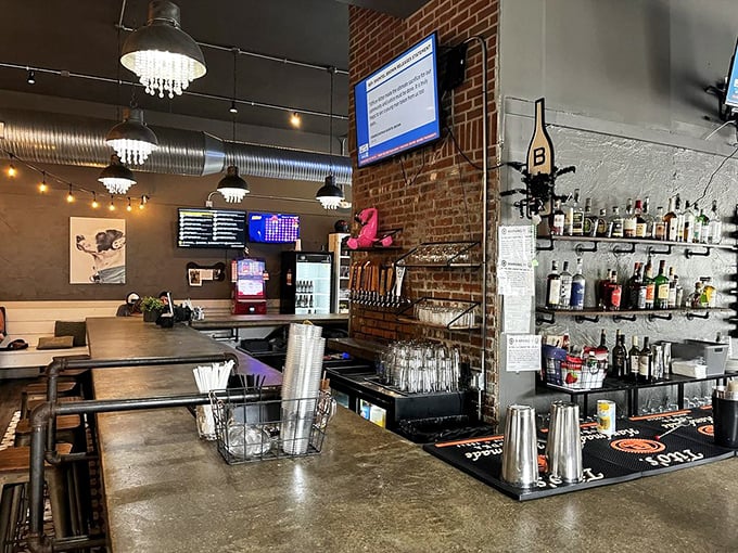 Behind the bar, function meets style with an impressive array of spirits. Those pendant lights cast the kind of glow that makes everyone look like they're starring in their own food show.