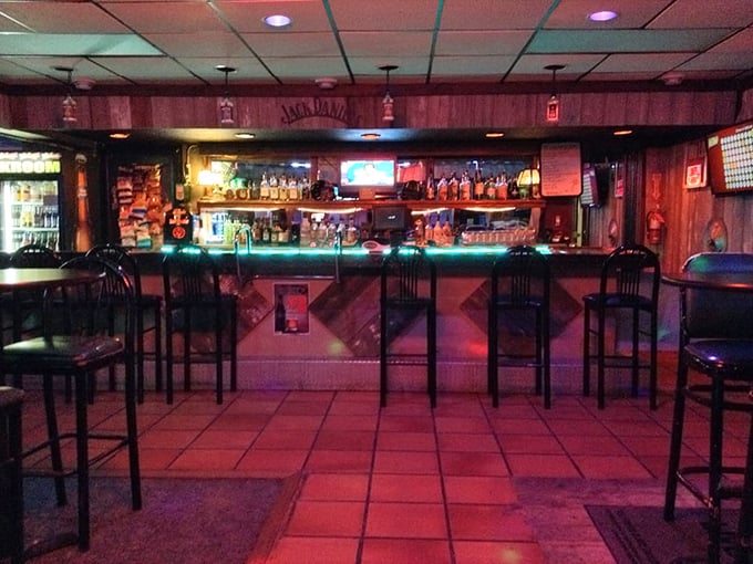 The bar glows with promise under neon lights, a beacon for those seeking both liquid refreshment and lively conversation.