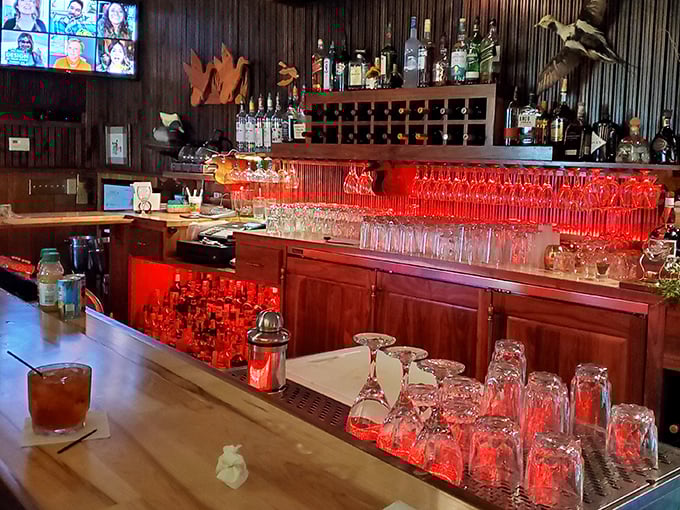 The bar glows red like the beating heart of the establishment. Those glasses stand ready for whatever life event you're celebrating – or escaping.