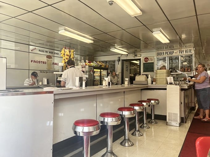 Chrome stools lined up like patient sentinels, waiting for the next generation of diners to spin while waiting for their burgers.