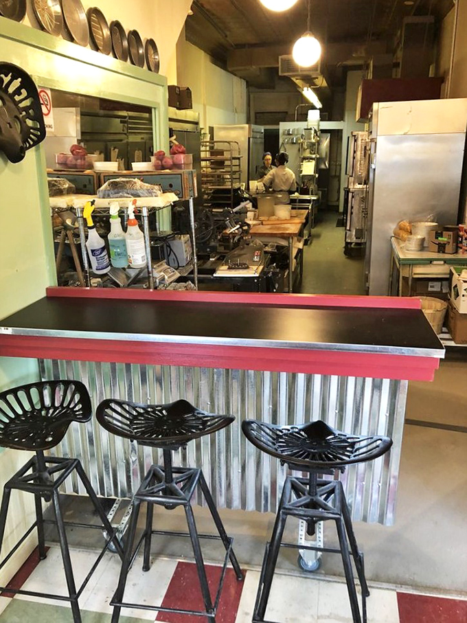Counter seating offers front-row views of the baking magic, where tractor-style stools meet culinary artistry.