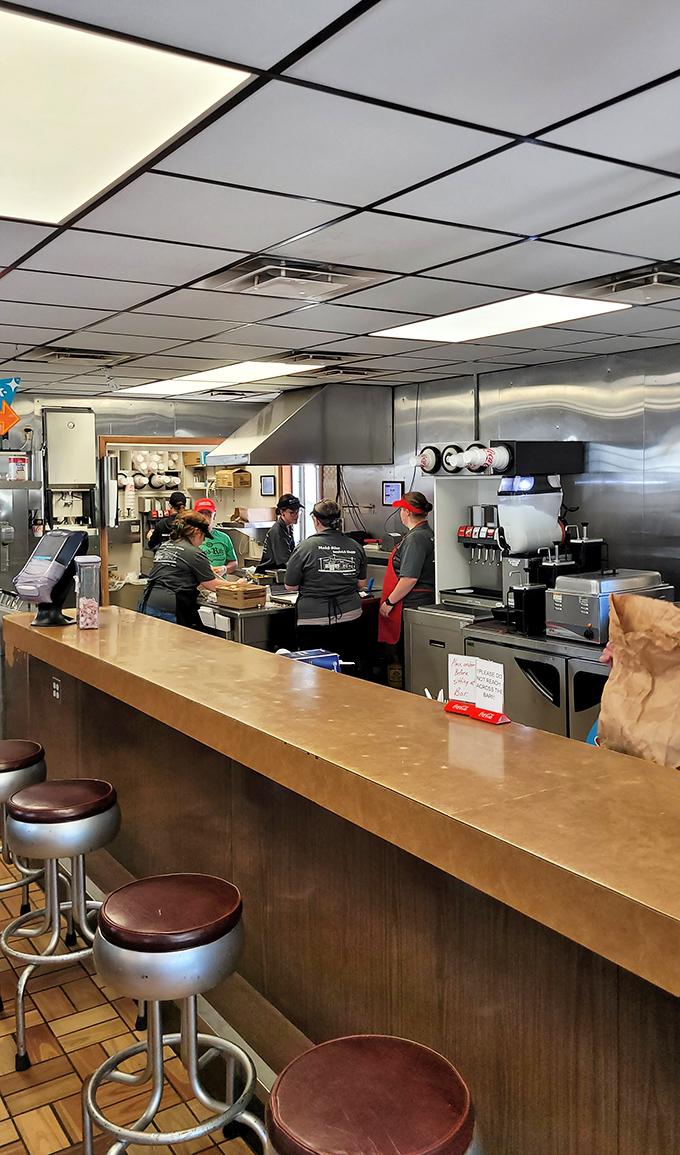 The kitchen choreography is mesmerizing—decades of sandwich-making expertise on display as orders fly and loose meat sizzles just feet away.