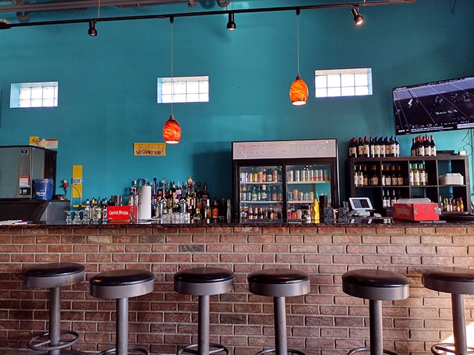 The brick-walled bar with turquoise accents feels like the beach and comfort had a perfectly designed baby.