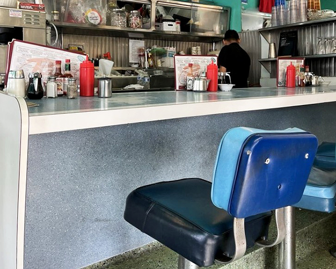 The counter—where solo diners find community, regulars have their "spots," and the coffee keeps flowing like conversation between old friends.