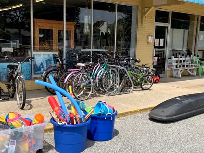 Beach cruisers and buckets of summer fun line the entrance—because nothing says "coastal living" like a secondhand bike with character.