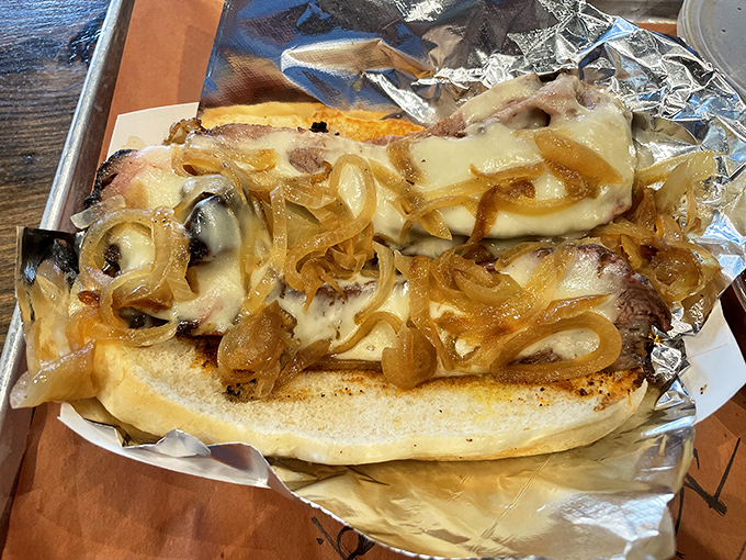 Melted cheese cascading over meat like a delicious lava flow. This sandwich doesn't just satisfy hunger—it obliterates it.