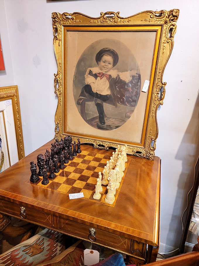 A vintage chess set beneath a portrait of a bygone era—two different ways to capture history in one magnificent corner.