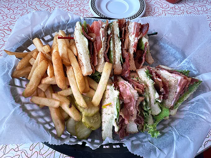 The club sandwich—three layers of nostalgia between toasted bread. Served with enough fries to share, though you probably won't want to.