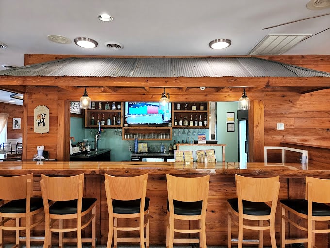 This isn't just a bar counter—it's front-row seating to the culinary theater where comfort food classics get their standing ovation.