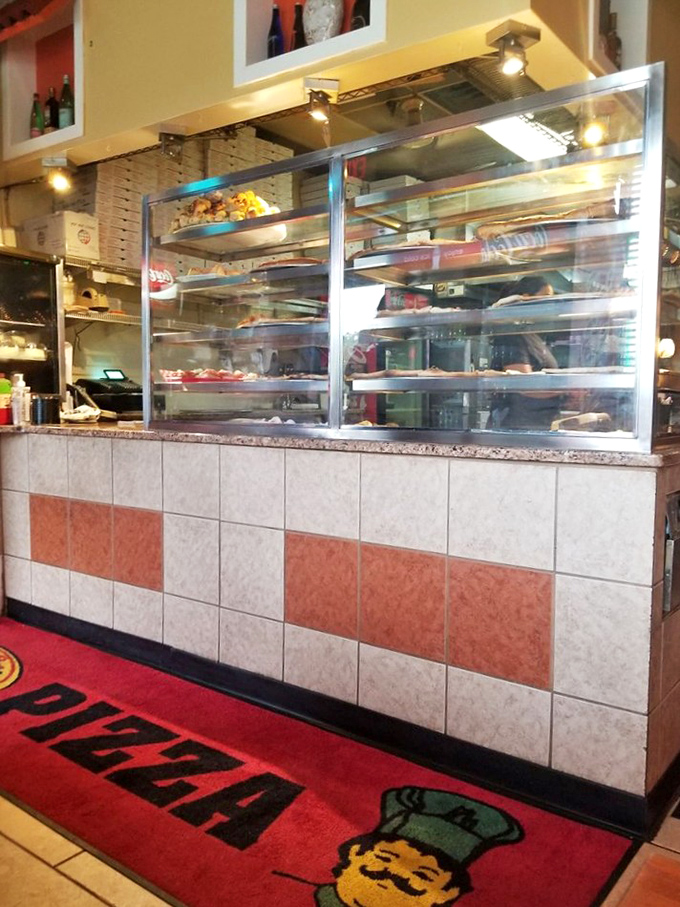 The counter area—where magic happens behind glass. Like watching artisans at work, there's something hypnotic about seeing your meal come togethe