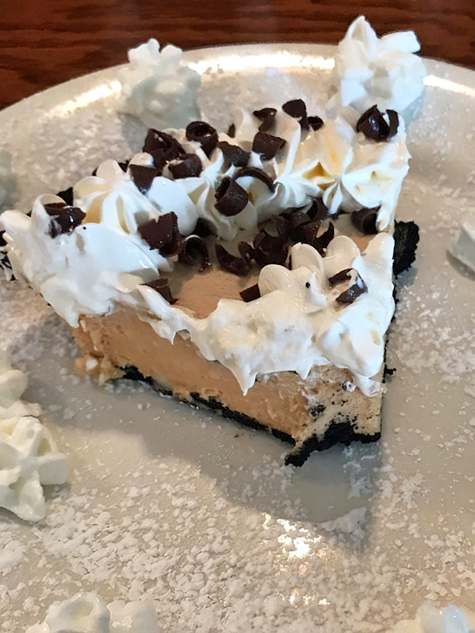 A slice of cream pie topped with chocolate bits and whipped cream – because sometimes breakfast should end with something sinfully sweet.