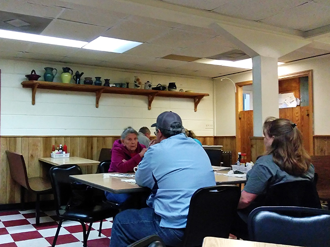 Morning conversations unfold under a collection of pottery pieces—local art meeting local appetites in a scene straight from small-town America.