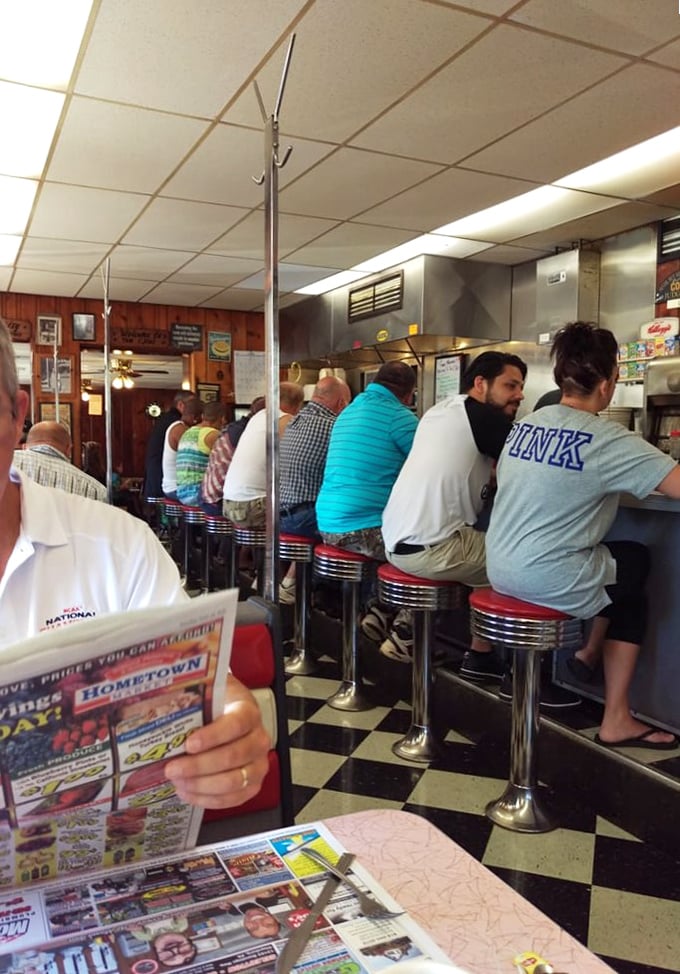 The lunch counter ballet—regulars know exactly which stool is theirs, and the perfect elbow-resting position for maximum coffee consumption.