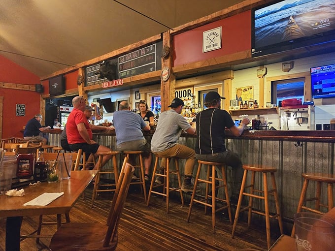 The bar area: where strangers become friends and friends become regulars. Notice how nobody's looking at their phones—the food commands full attention.