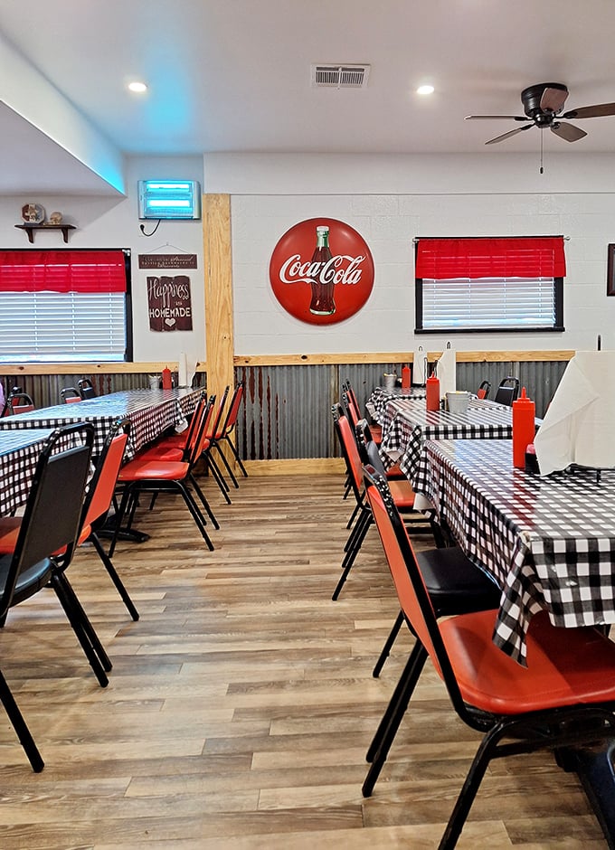 Red chairs, checkered tablecloths, and Coca-Cola signs—the holy trinity of authentic country cafes. No interior designer needed when you've got tradition.
