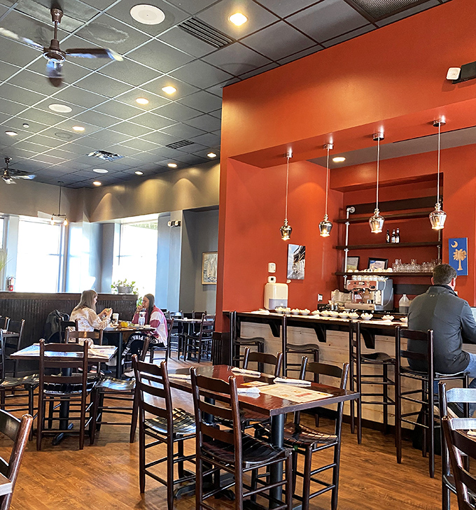 Modern pendant lighting, warm earth tones, and thoughtful spacing between tables—because nobody wants to accidentally join someone else's breakfast conversation.