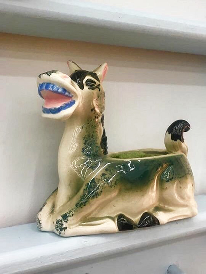The world's happiest donkey planter looks like it escaped from a 1950s acid trip. Someone's grandmother definitely had this on her coffee table!