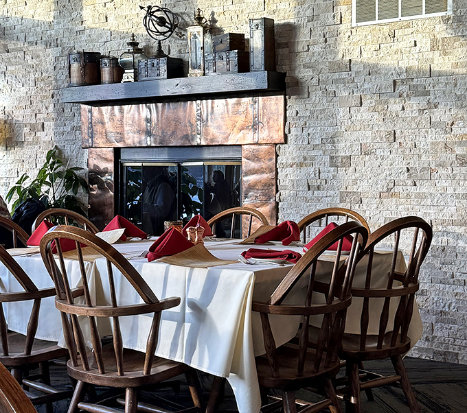 Stone fireplace, copper accents, and tables set with care—this isn't just dining; it's the Wisconsin version of hygge with better food.