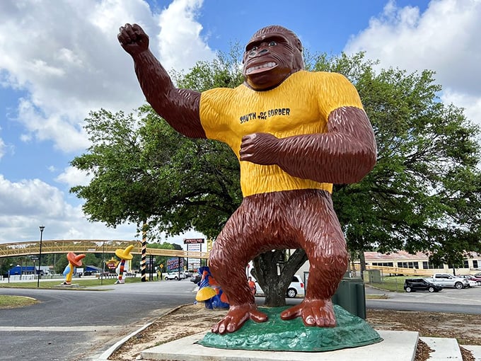 This gorilla statue proudly sports a "South of the Border" t-shirt, proving even giant primates can't resist the gift shop. 