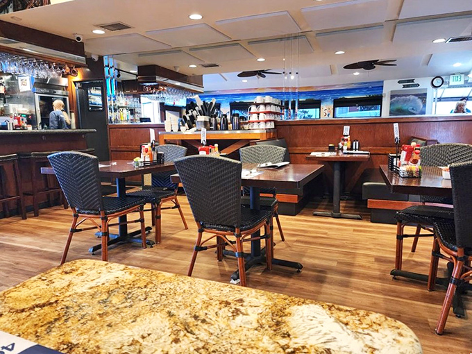 The dining room's woven chairs and wooden tables speak to a coastal aesthetic that says, "Stay awhile, the waves can wait."