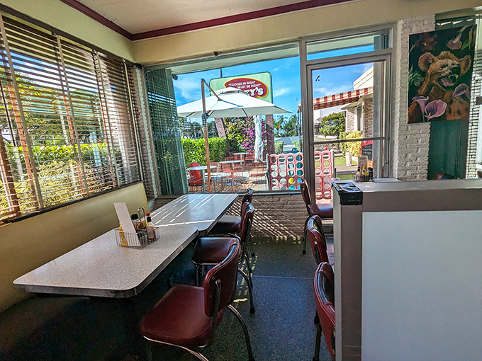 Sunshine streams through windows, illuminating a corner where conversations and coffee flow freely—the kind of spot where "just stopping in" turns into two delightful hours. 