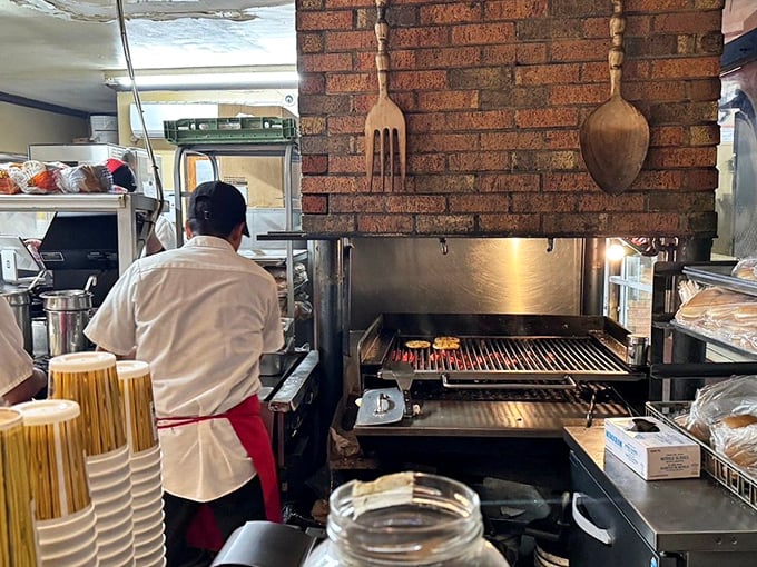 The open flame charcoal grill—where burger magic happens. No wonder these patties have a smoky depth that fast food chains can only dream about.