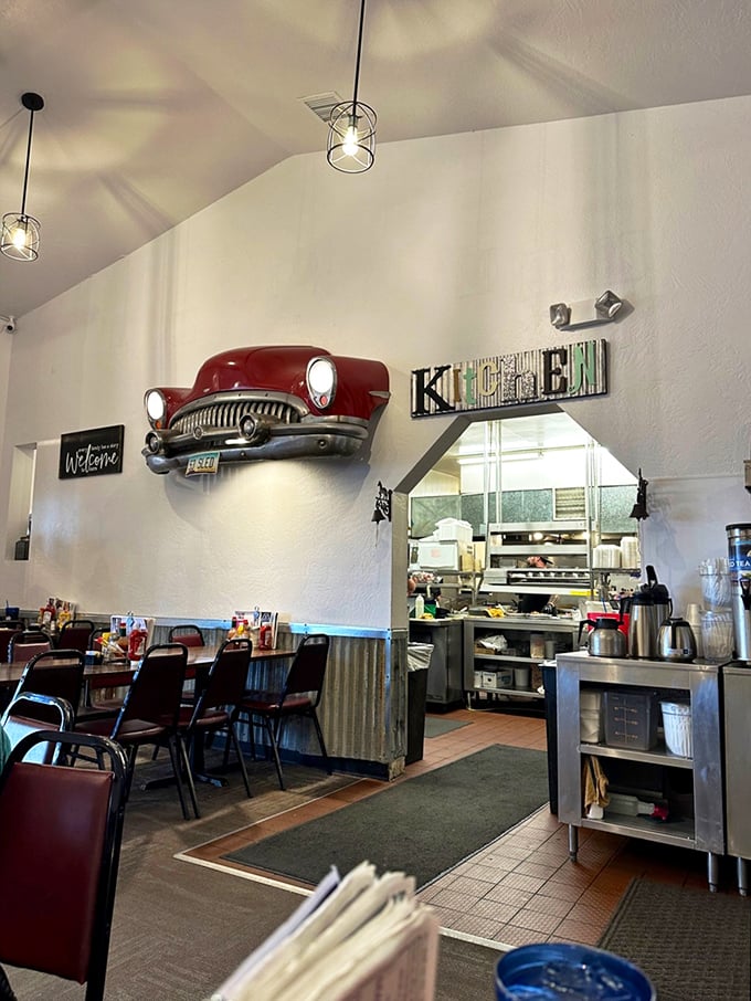 That vintage car mounted on the wall isn't just decor—it's watching over the kitchen like an automotive guardian angel of flavor.