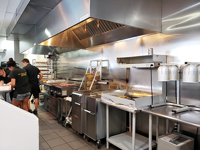 Behind the scenes, the kitchen's stainless steel symphony reveals where the burger magic happens—no smoke and mirrors, just honest cooking.