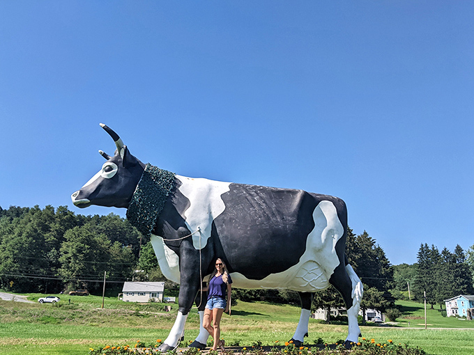 "For scale, I brought a human." The sheer magnitude of this bovine behemoth becomes clear when standing beside it—like posing with a dairy-themed skyscraper.