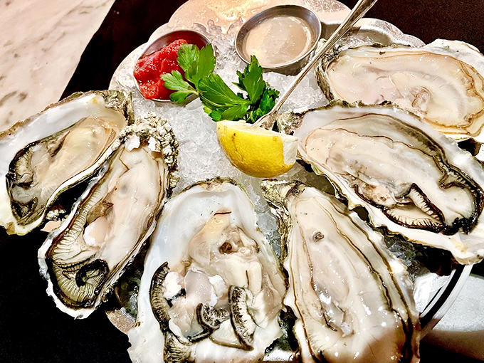 Oysters arranged like precious jewels on a bed of ice—briny treasures from the sea that taste like the ocean's finest moment.