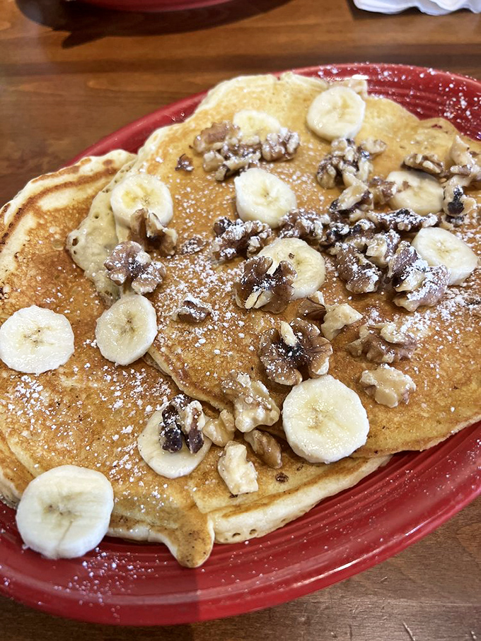 Banana walnut pancakes that deserve their own zip code. That dusting of powdered sugar isn't decoration—it's pancake jewelry.