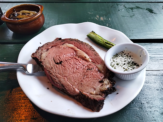 Prime rib cooked to that perfect shade of pink that makes meat lovers go quiet for a moment of respectful silence before diving in.