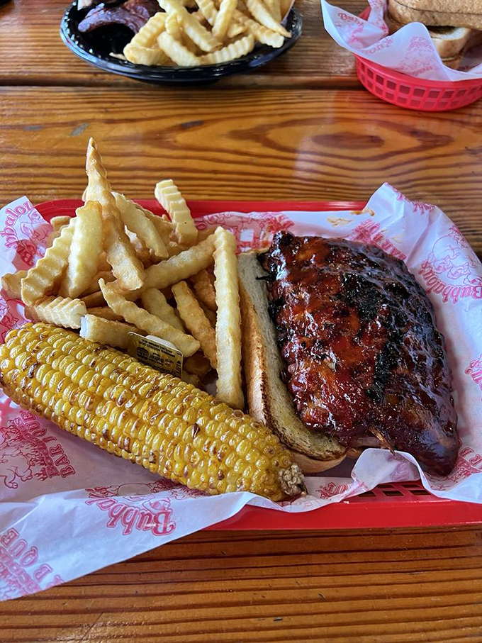 A barbecue plate that hits all the right notes – smoky chicken, golden fries, and corn on the cob that's ready for its close-up.