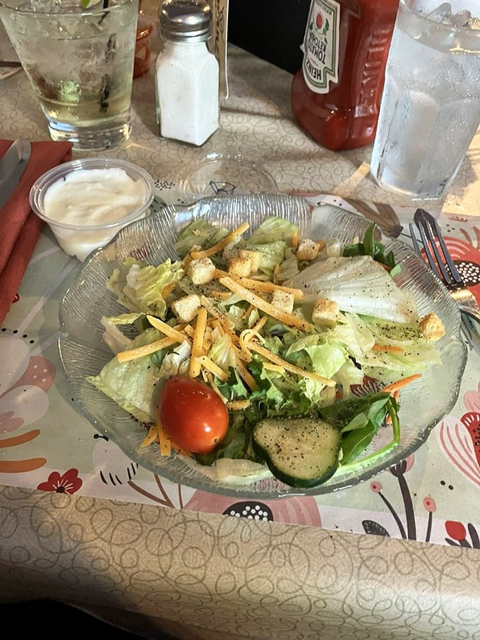 The humble house salad—crisp, fresh, and thoughtfully composed—a palate-cleansing prelude to the richness that follows.