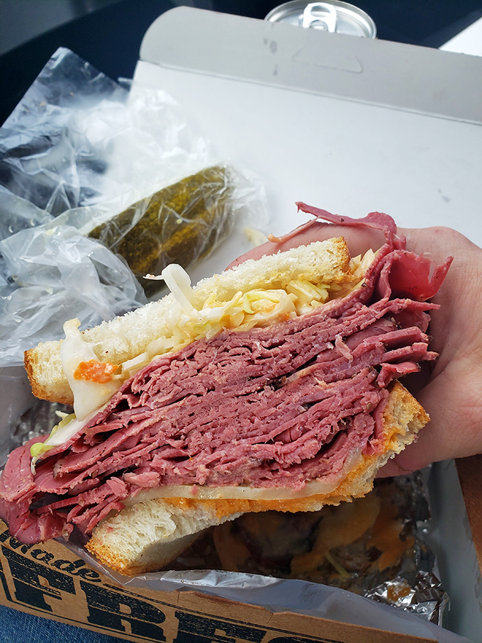 A sandwich so packed with corned beef it requires jaw exercises beforehand. This isn't lunch—it's a commitment to excellence.
