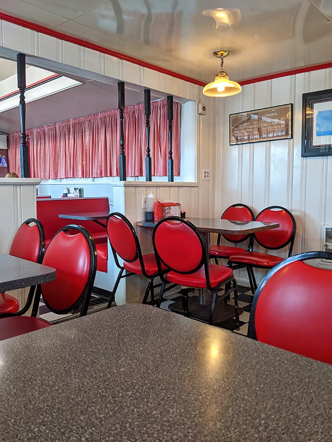 These cherry-red chairs aren't just seating – they're front-row tickets to the greatest show on earth: breakfast in America.