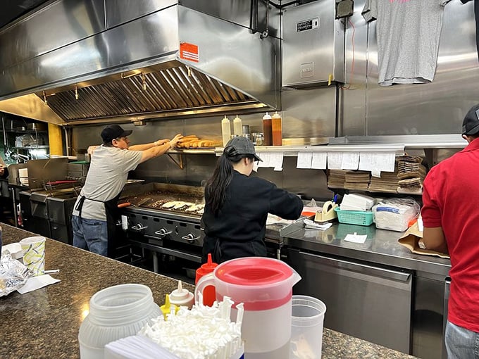 The kitchen choreography is mesmerizing—spatulas flying, meat sizzling, and sandwiches emerging like edible works of art. True craftspeople at work.