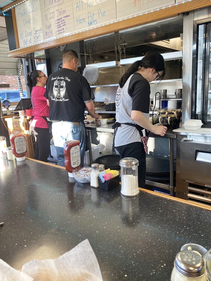 Where the magic happens – kitchen staff orchestrating the breakfast symphony that keeps locals coming back for encores.
