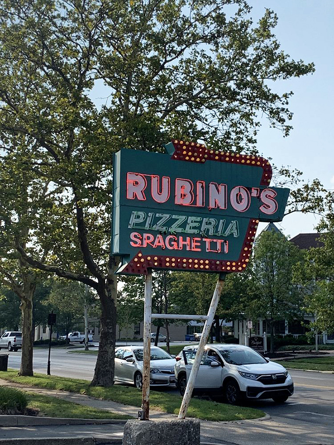 The vintage sign stands proud against the Ohio sky. Those bulbs have illuminated the way to pizza paradise since Eisenhower was president.