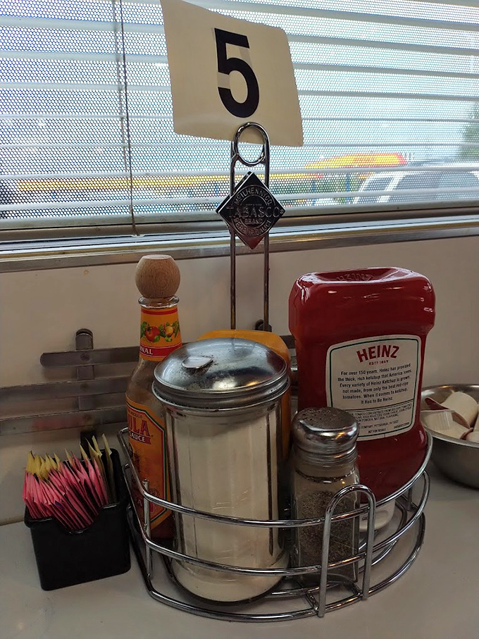 Table 5's condiment caddy—the silent supporting cast that deserves its own credit roll in the meal's final production.
