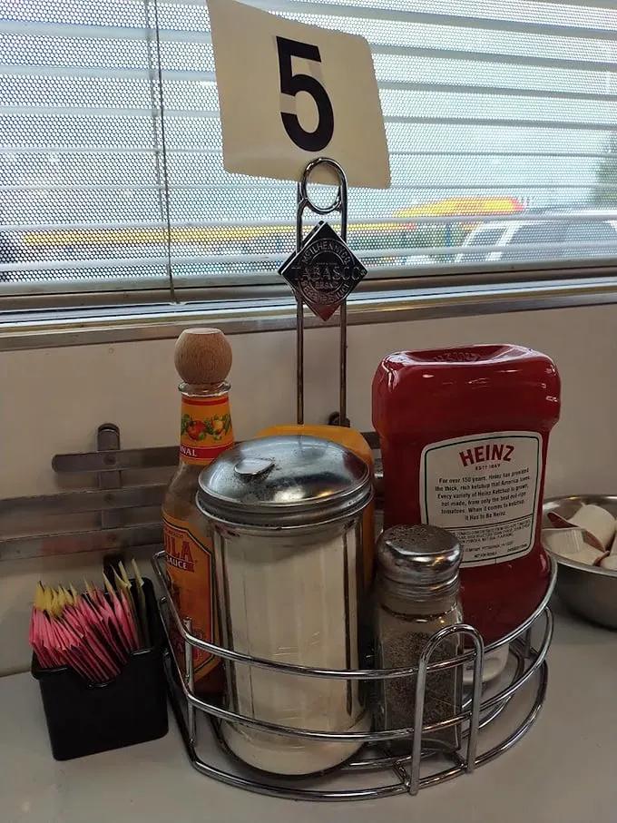 Table 5's condiment caddy—the silent supporting cast that deserves its own credit roll in the meal's final production.