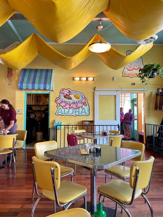 Yellow chairs, yellow drapes, and "Aloha" signs—this isn't just a dining room, it's a vacation for your breakfast routine.