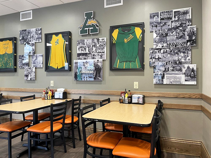 The dining area's green and gold sports décor celebrates local pride, creating an atmosphere where every table feels like you're sitting in the hometown bleachers.