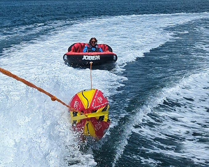Water tubing in the Gulf—where "hanging out" means being dragged behind a boat at exhilarating speeds while screaming with joy.