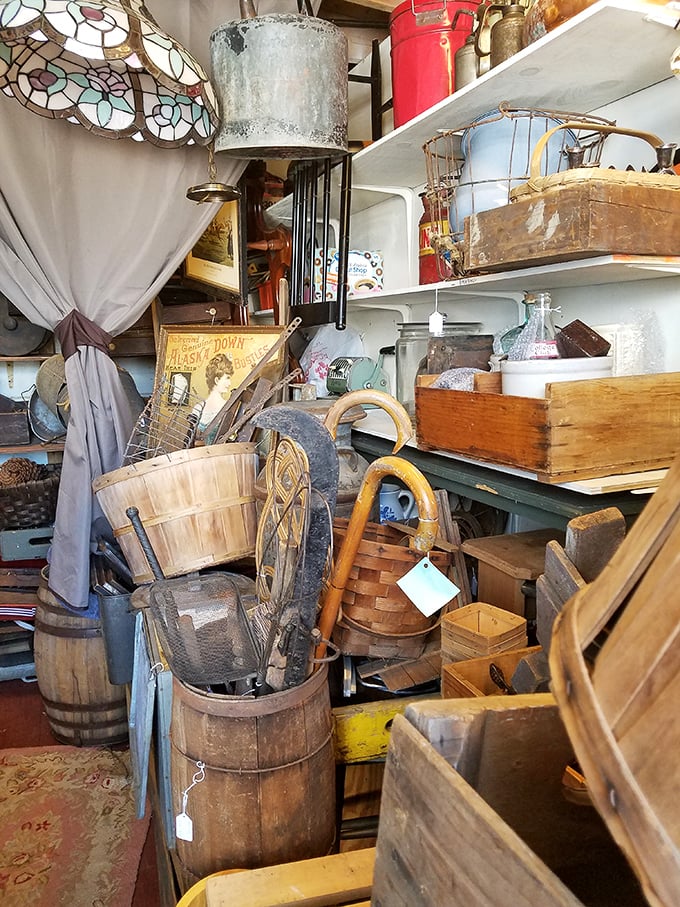Wooden barrels, baskets, and bygones stacked in beautiful chaos. That Tiffany-style lamp shade peeking from above has probably illuminated several decades of family dinners. 